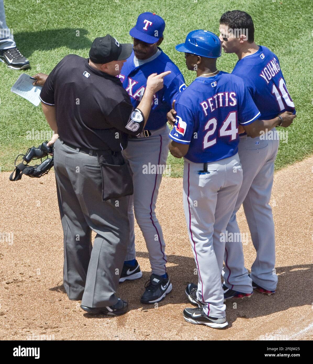 Texas Rangers manager Ron Washington, second from left, argues a third ...