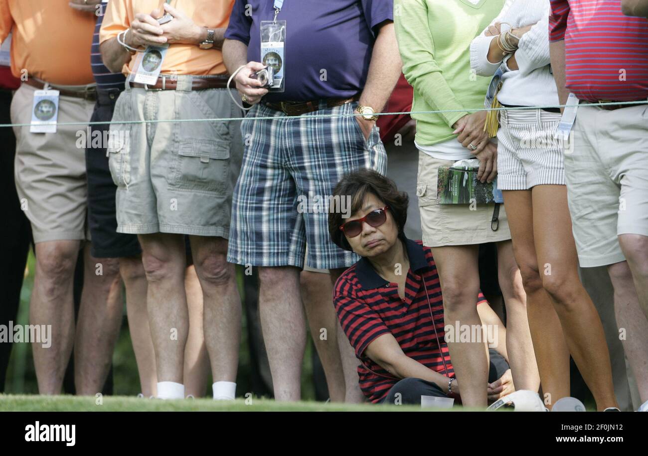Patrons wait for Tiger Woods on No. 7 during a practice round for the ...
