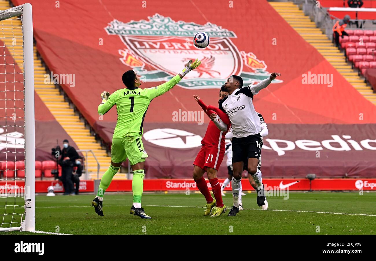 Fulham goalkeeper Alphonse Areola saves from Liverpool's Mohamed Salah ...
