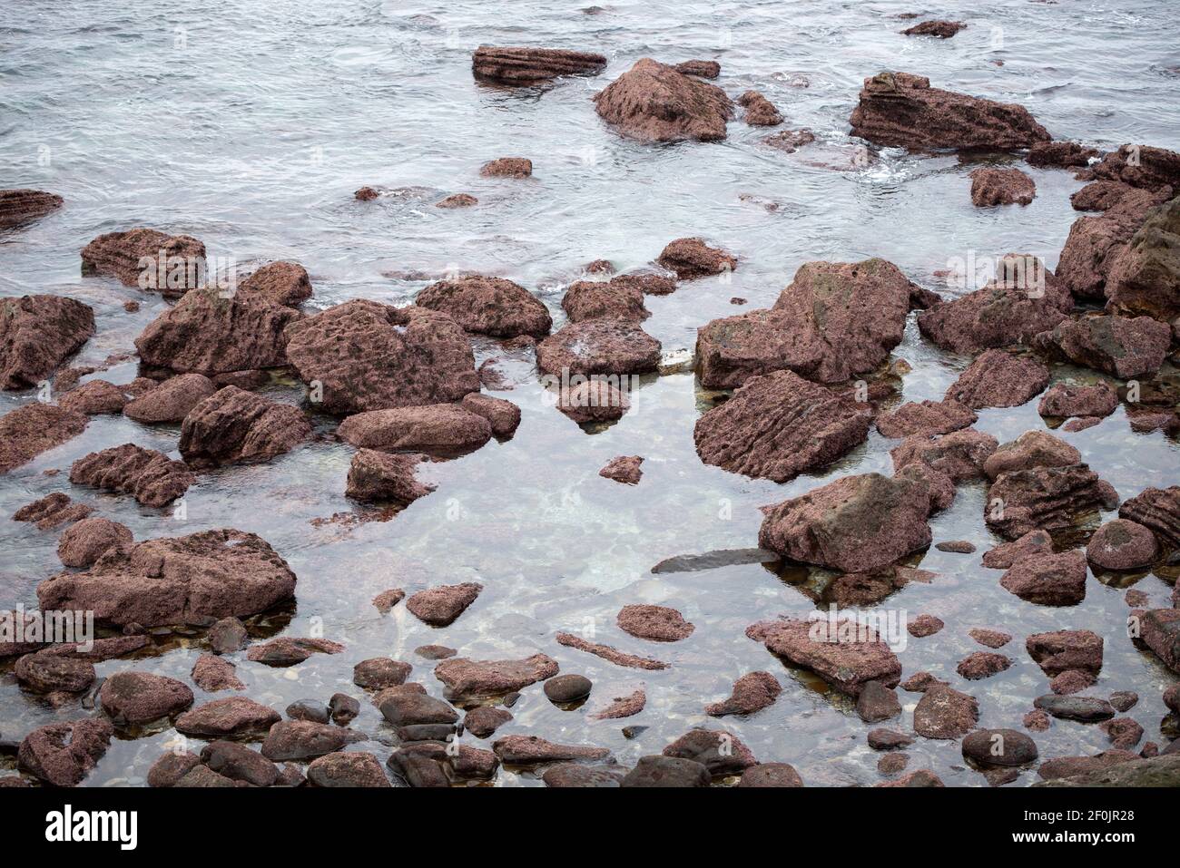 rocks coming out of the sea Stock Photo - Alamy