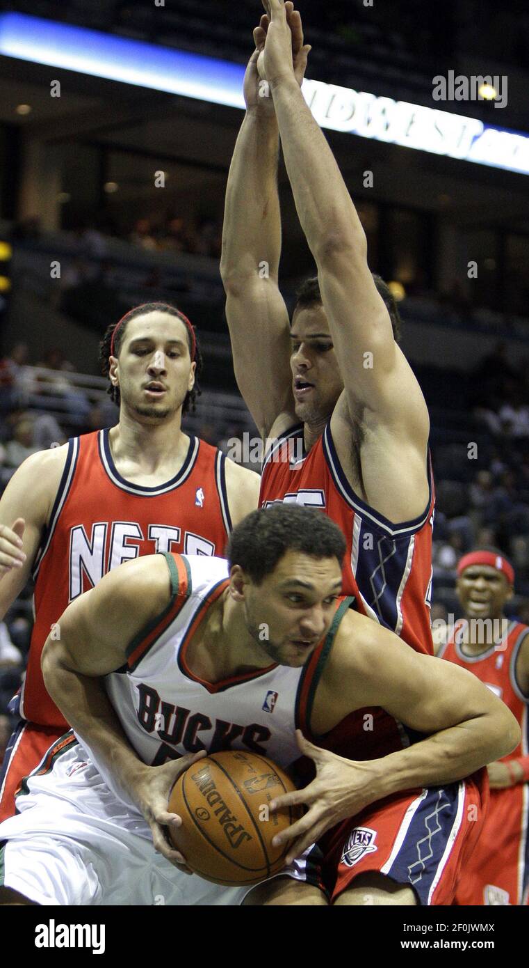 Milwaukee Bucks Dan Gadzuric gets around New Jersey Nets Kris Humphries ...