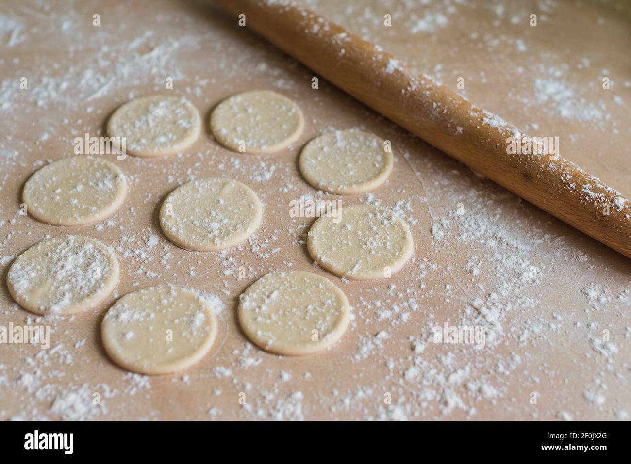 Dough circles and rolling pin Stock Photo - Alamy