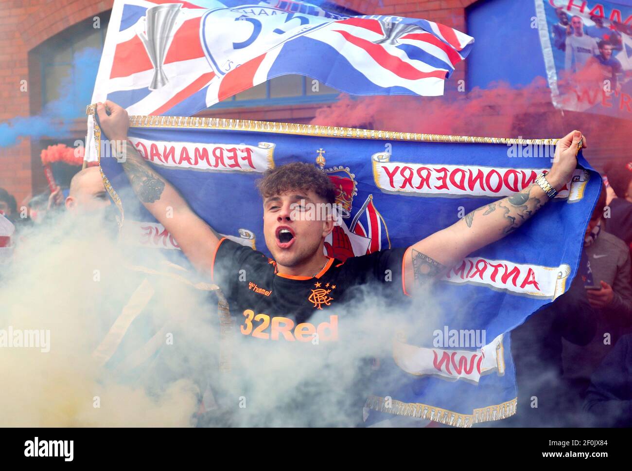A Rangers fan celebrates outside of the Ibrox Stadium after Rangers win ...