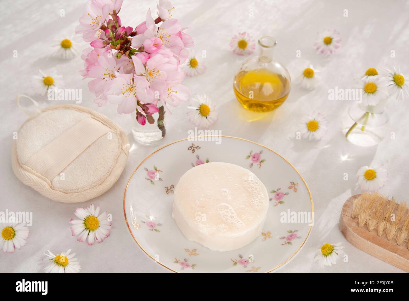 Homemade soap or shampoo with oil and flowers on the side Stock Photo ...
