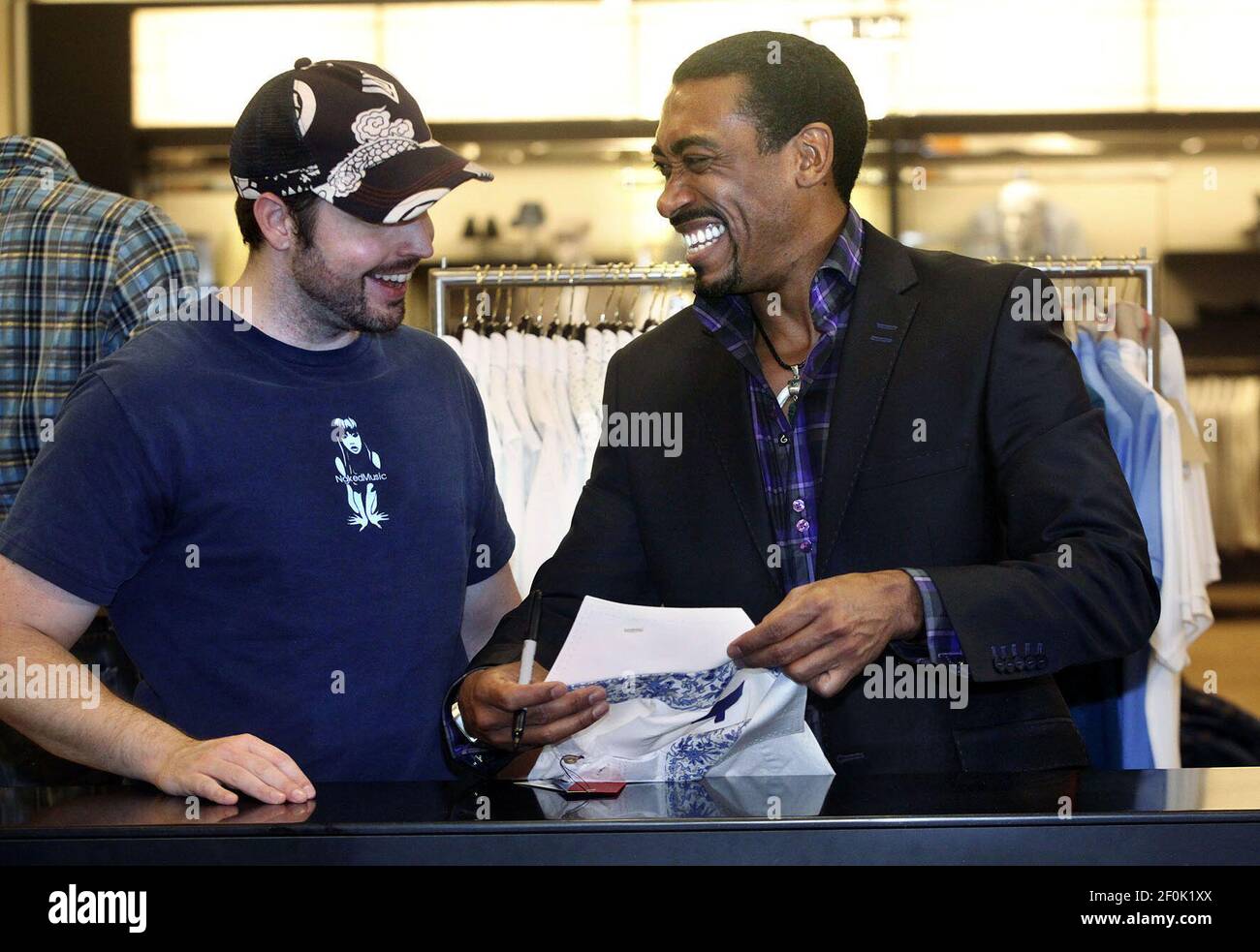 Bogosse CEO Patrick Tardieu, right, signs the collar of a new shirt for ...