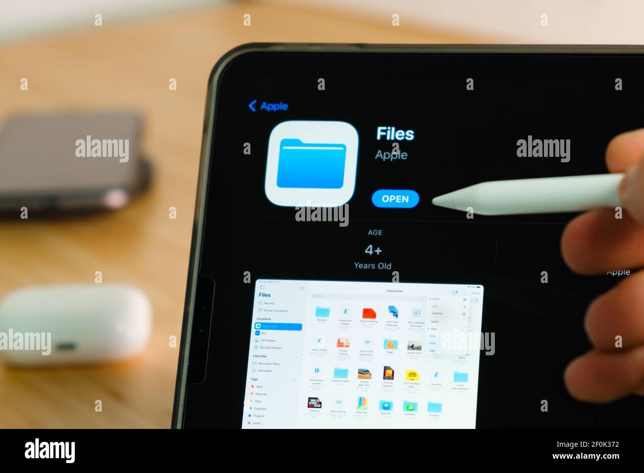 Files logo shown by apple pencil on the iPad Pro tablet screen. Man ...