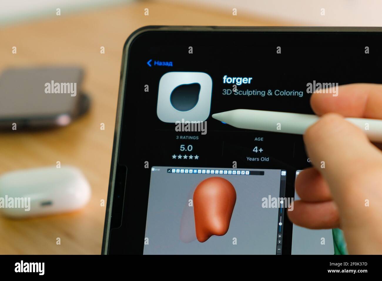 Forger logo shown by apple pencil on the iPad Pro tablet screen. Man ...