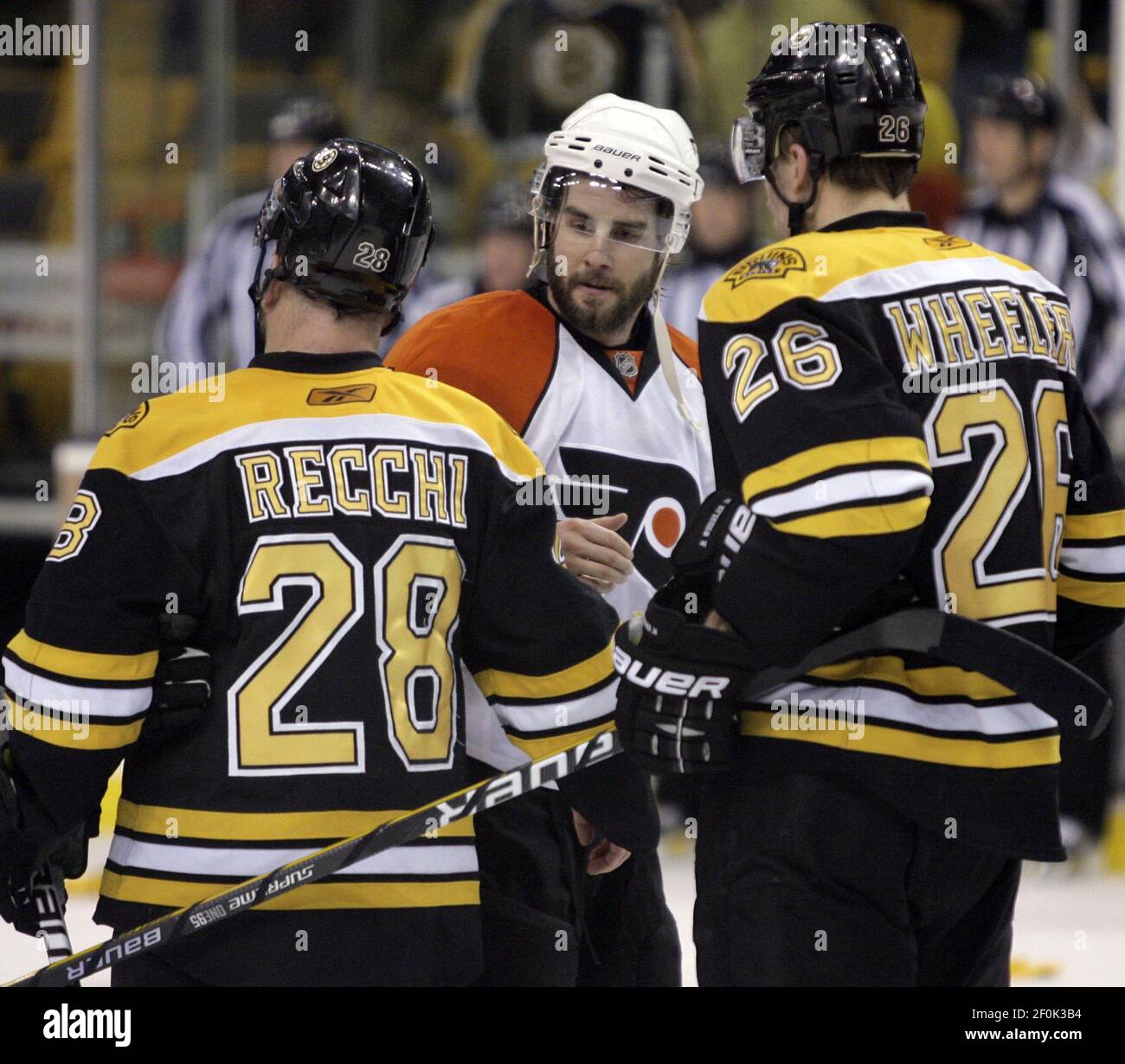 The Philadelphia Flyers' Simon Gagne, center, meets with Boston Bruins ...
