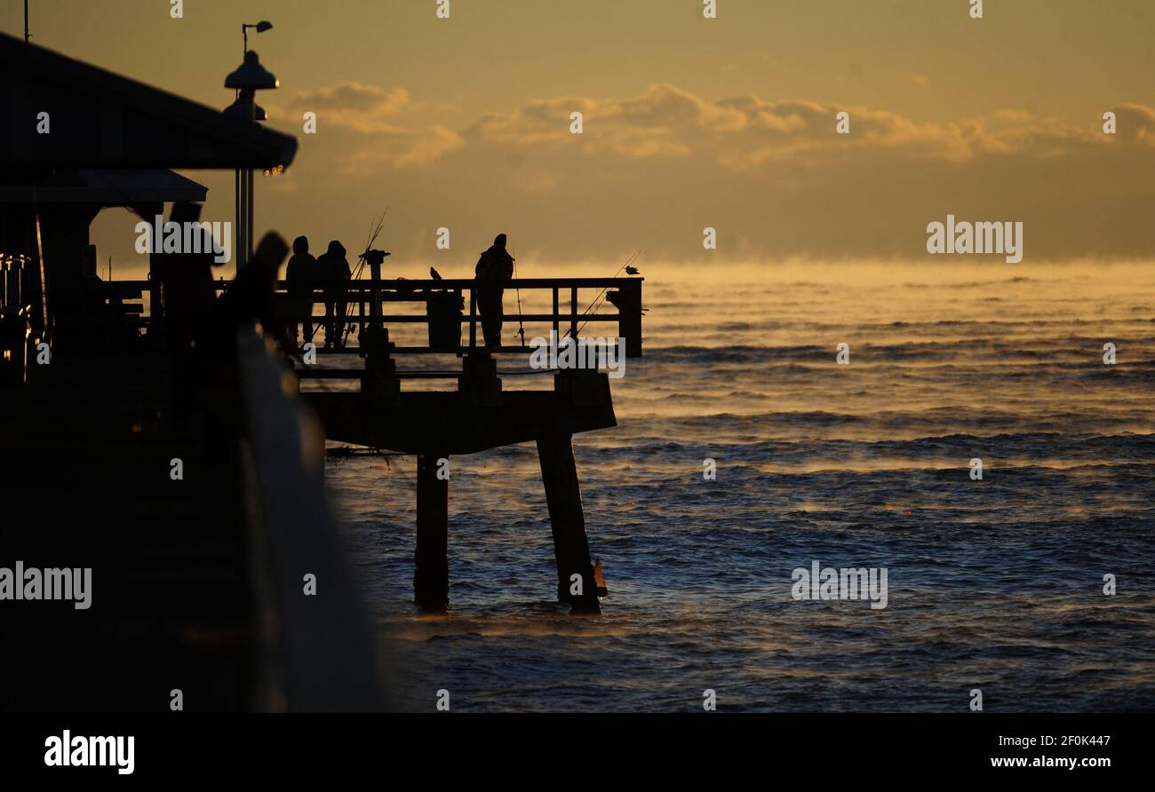 Steam rises off of the Atlantic Ocean as the sun comes up at Anglin's ...
