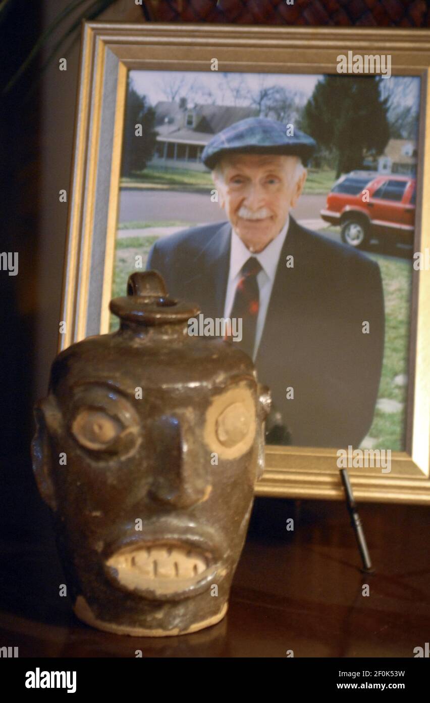 The Edgefield face jug sits next to a photo of Robert Strang, who ...