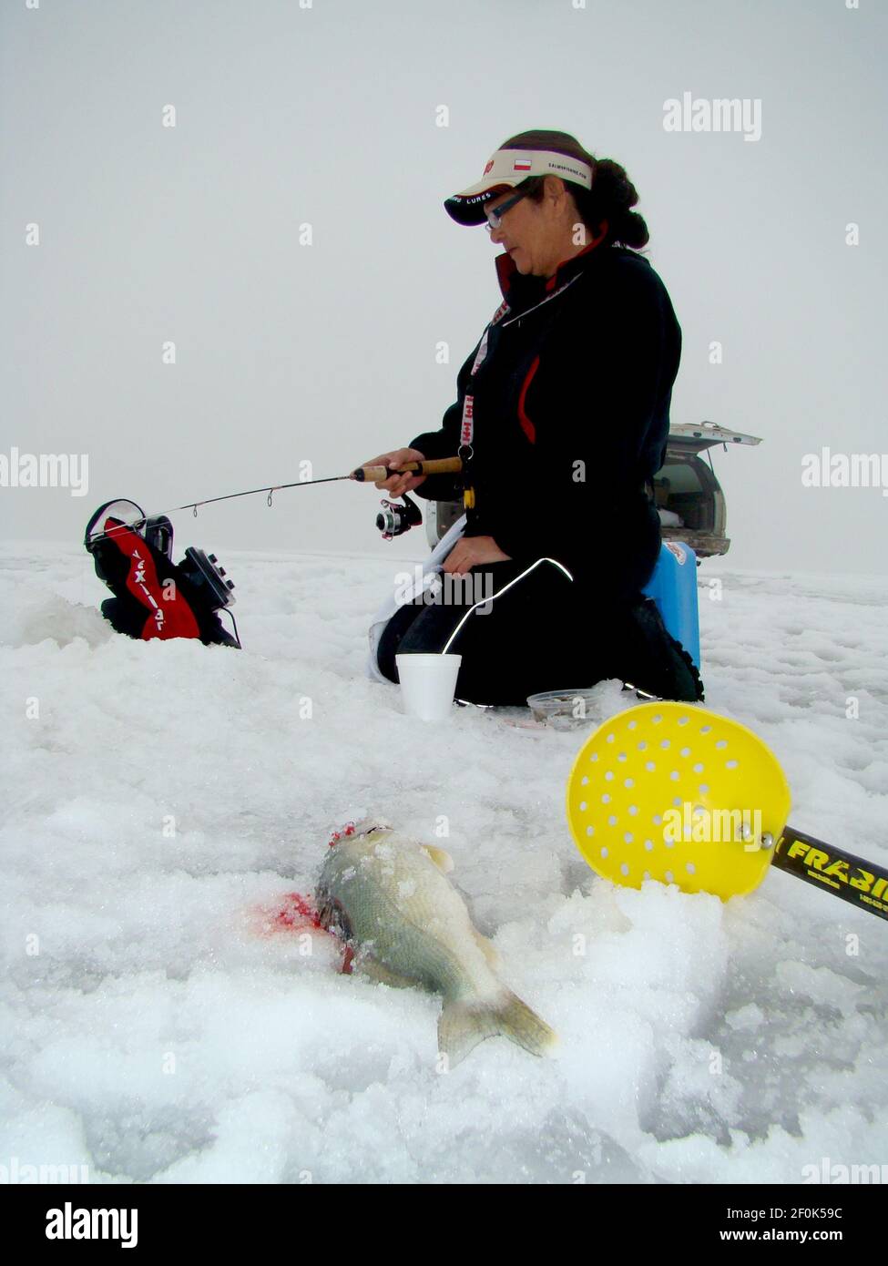Fishing guide Holly Chow watches the screen of her depth finder as she ...
