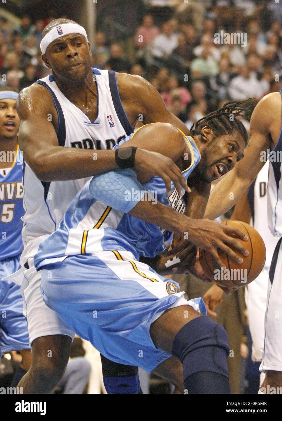 Brendan Haywood of the Dallas Mavericks guards Nene of the Denver ...