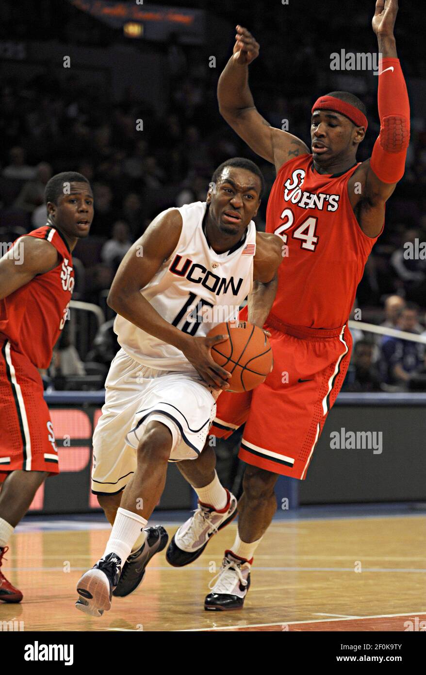 Kemba Walker of Connecticut was fouled as he drives past Justin Burrell ...
