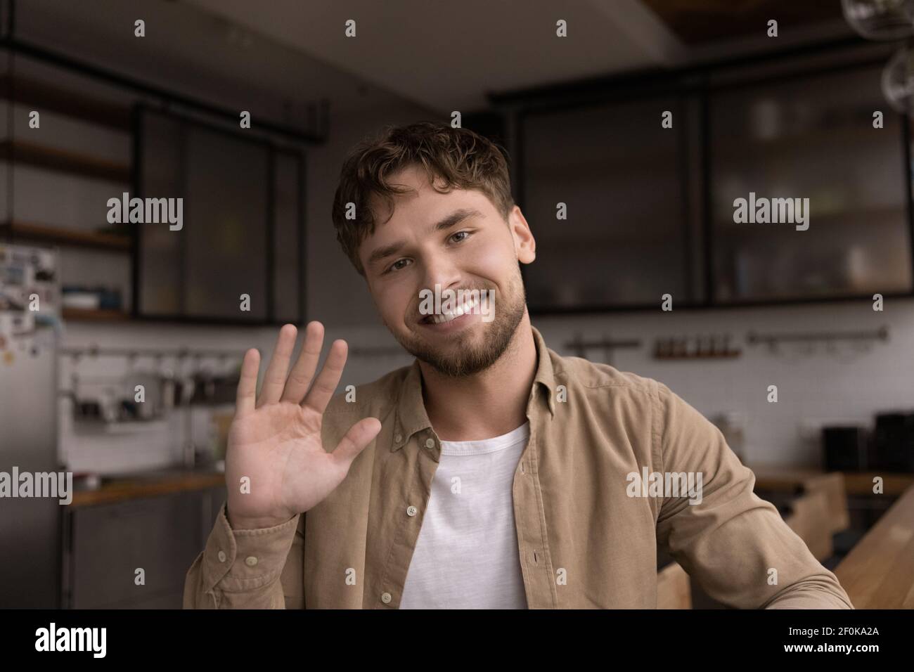 Head shot portrait smiling man waving hand at camera Stock Photo - Alamy