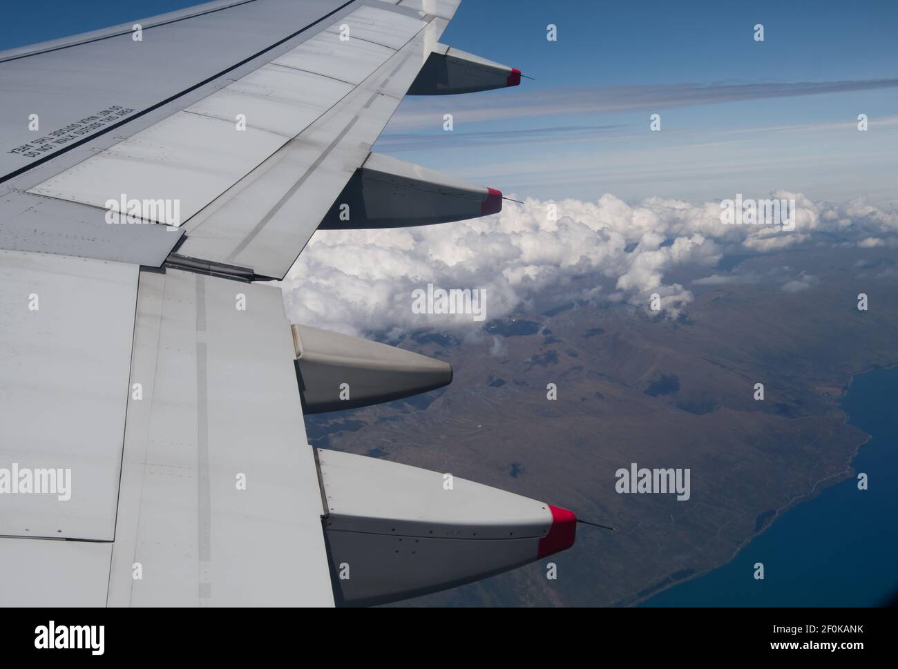 View of airplane wing out of plane window flying over New Zealand view ...