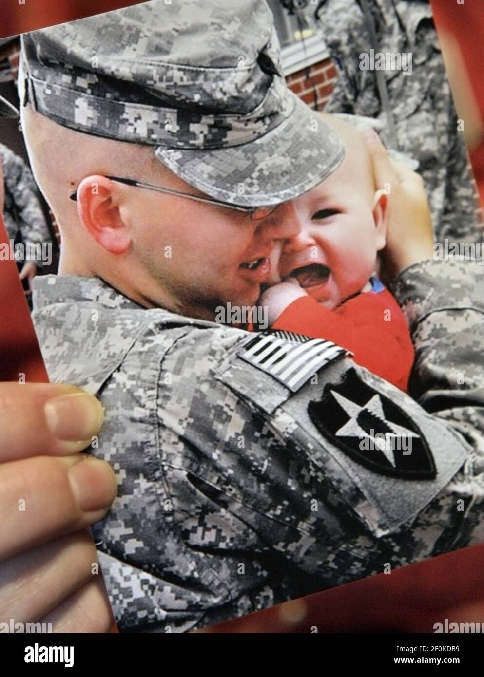 Cynthia Woodard, mother of deceased Army Spc. Michael Scusa, holds a ...