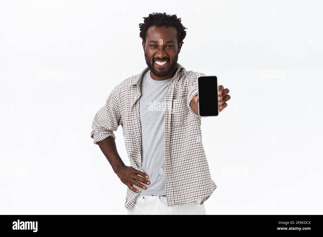 Satisfied enthusiastic young african-american smiling man showing ...