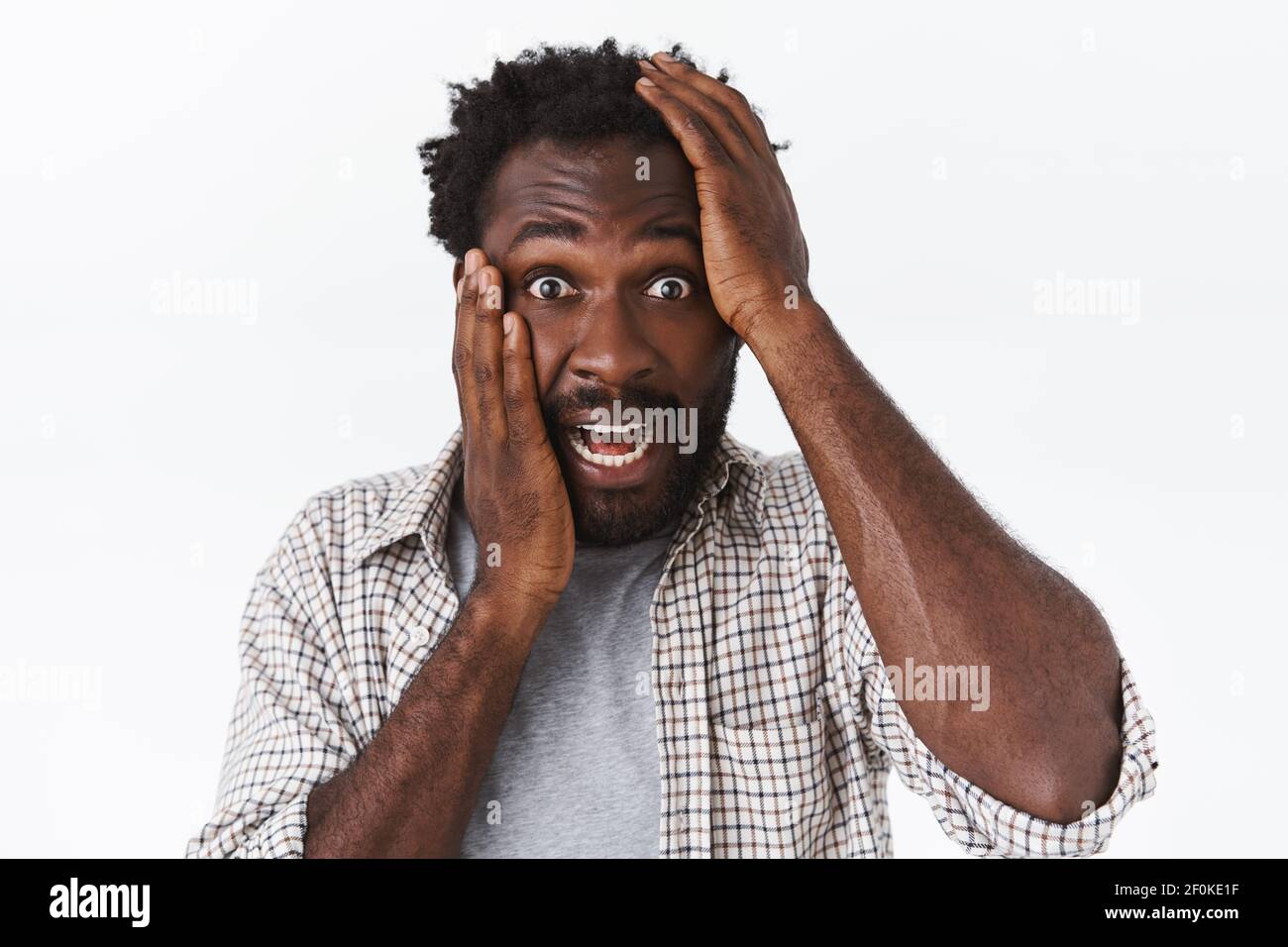 Guy scared, stare with panic and shock, touching face cant recognize ...