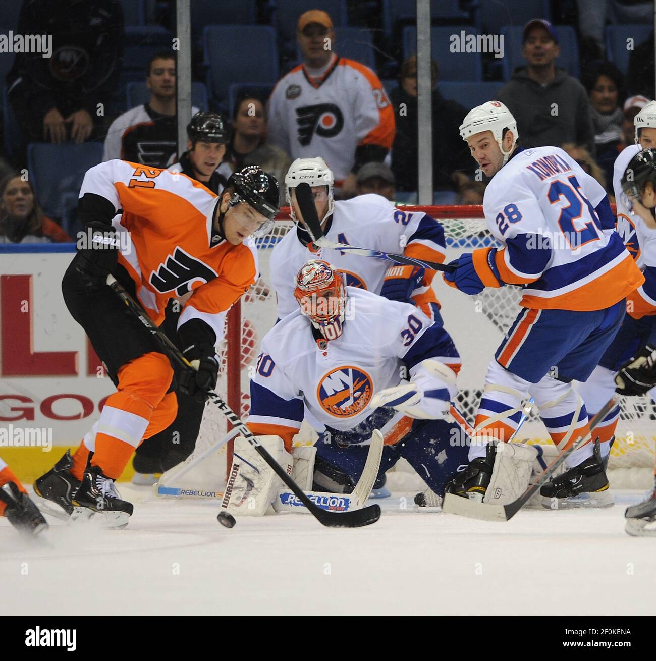 New York Islanders goalie Dwayne Roloson eyes a loose puck, as ...