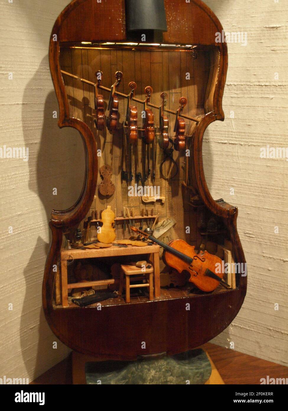 A real violin is opened to reveal a miniature violin-making shop at the ...