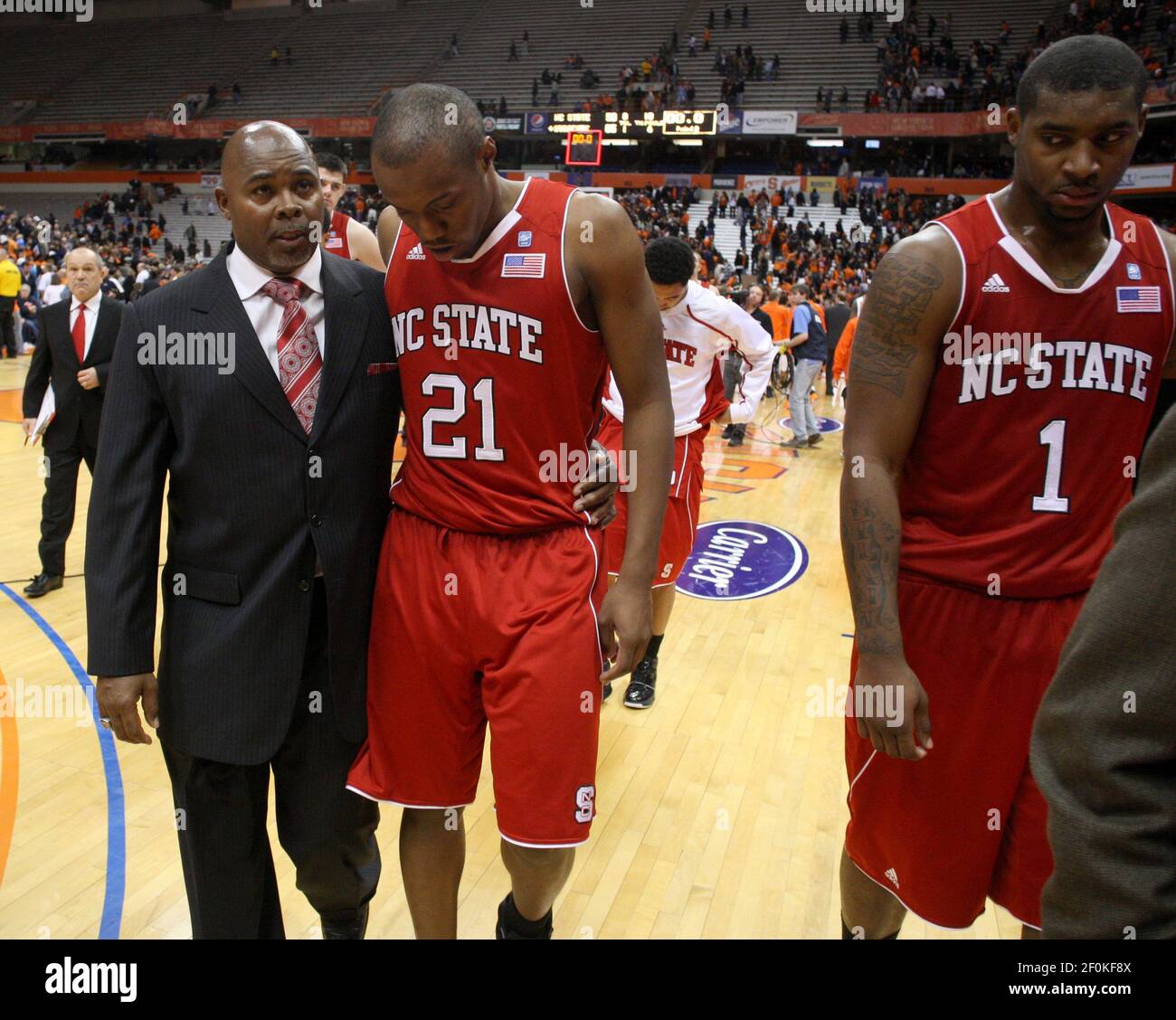 North Carolina State coach Sidney Lowe, left, walks off the court with ...