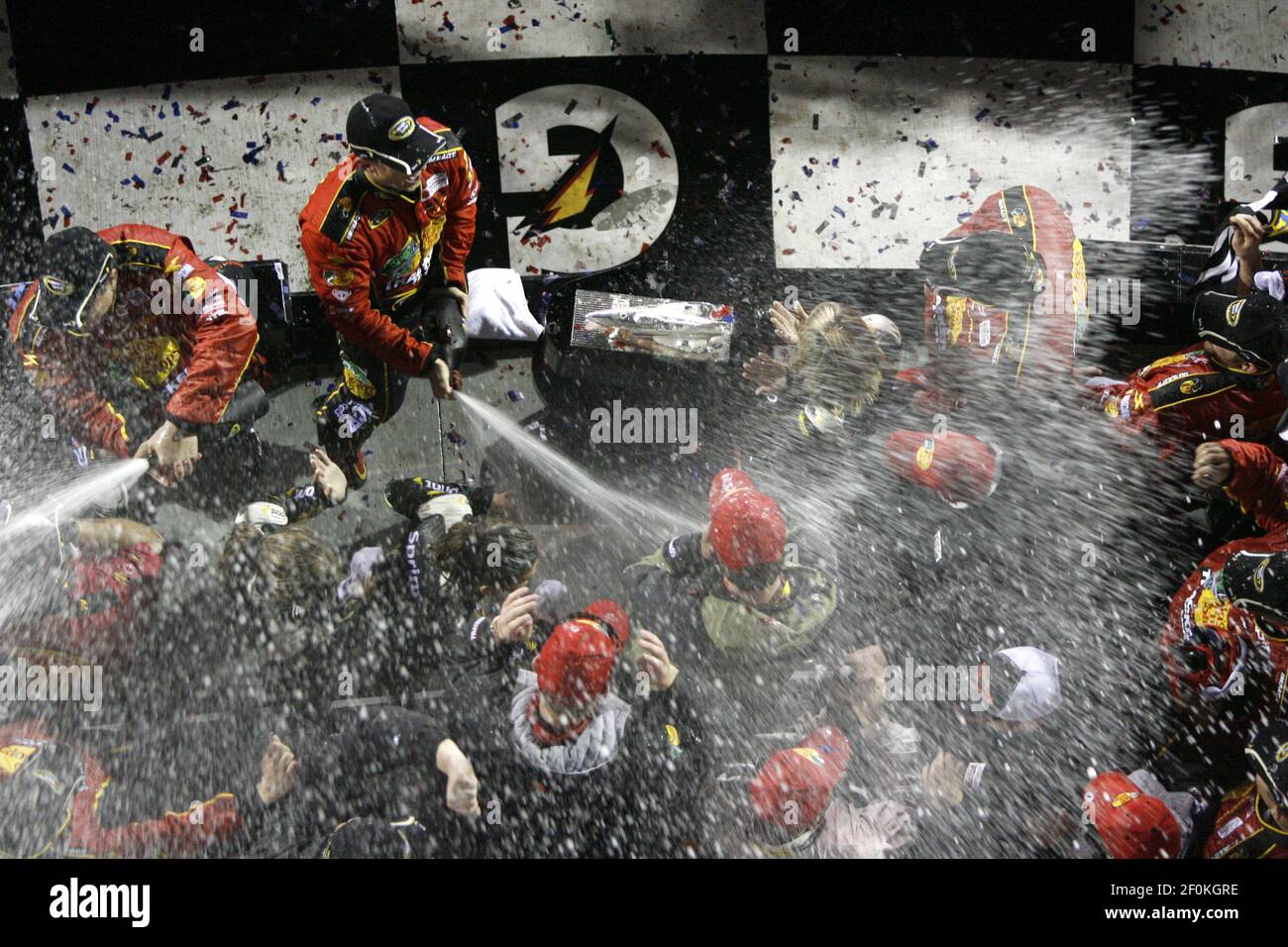 Jamie McMurray sprays his crew with champagne in Victory Lane after ...