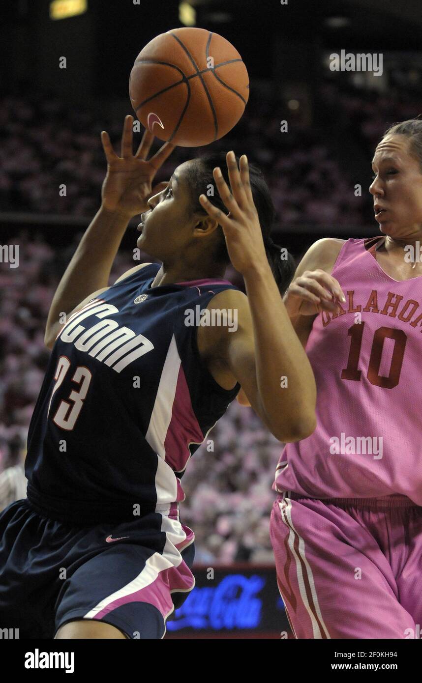 Maya Moore of Connecticut tries to get a grip on a ball as Carlee ...