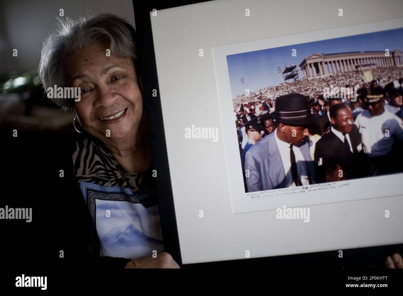 Helen Batson, 70, holds a picture taken by photographer Art Shay that ...