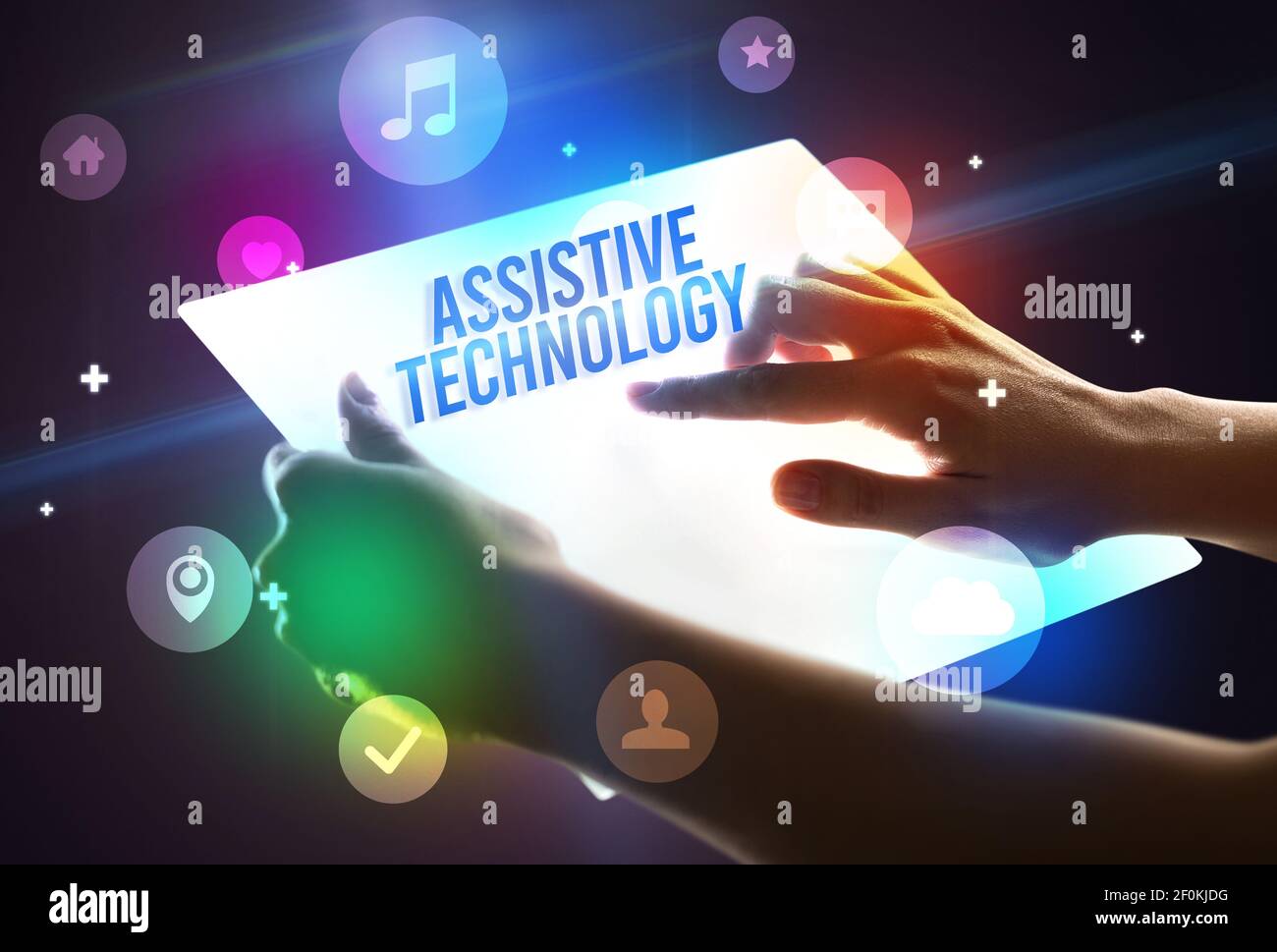 Holding futuristic tablet with ASSISTIVE TECHNOLOGY inscription, new ...