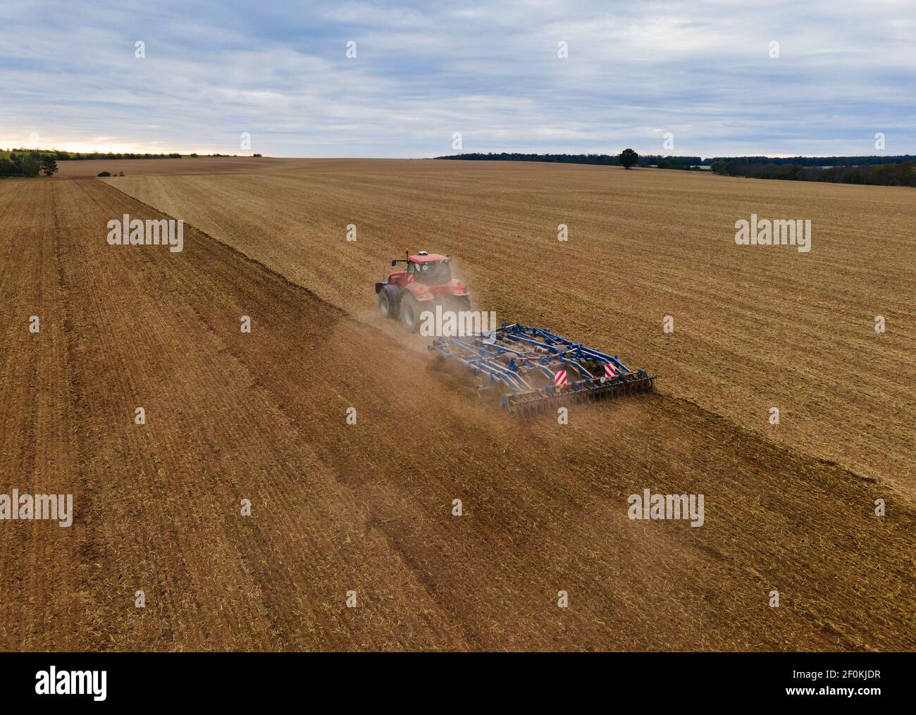 Farmer with tractor on wide field tilling the soil Stock Photo - Alamy