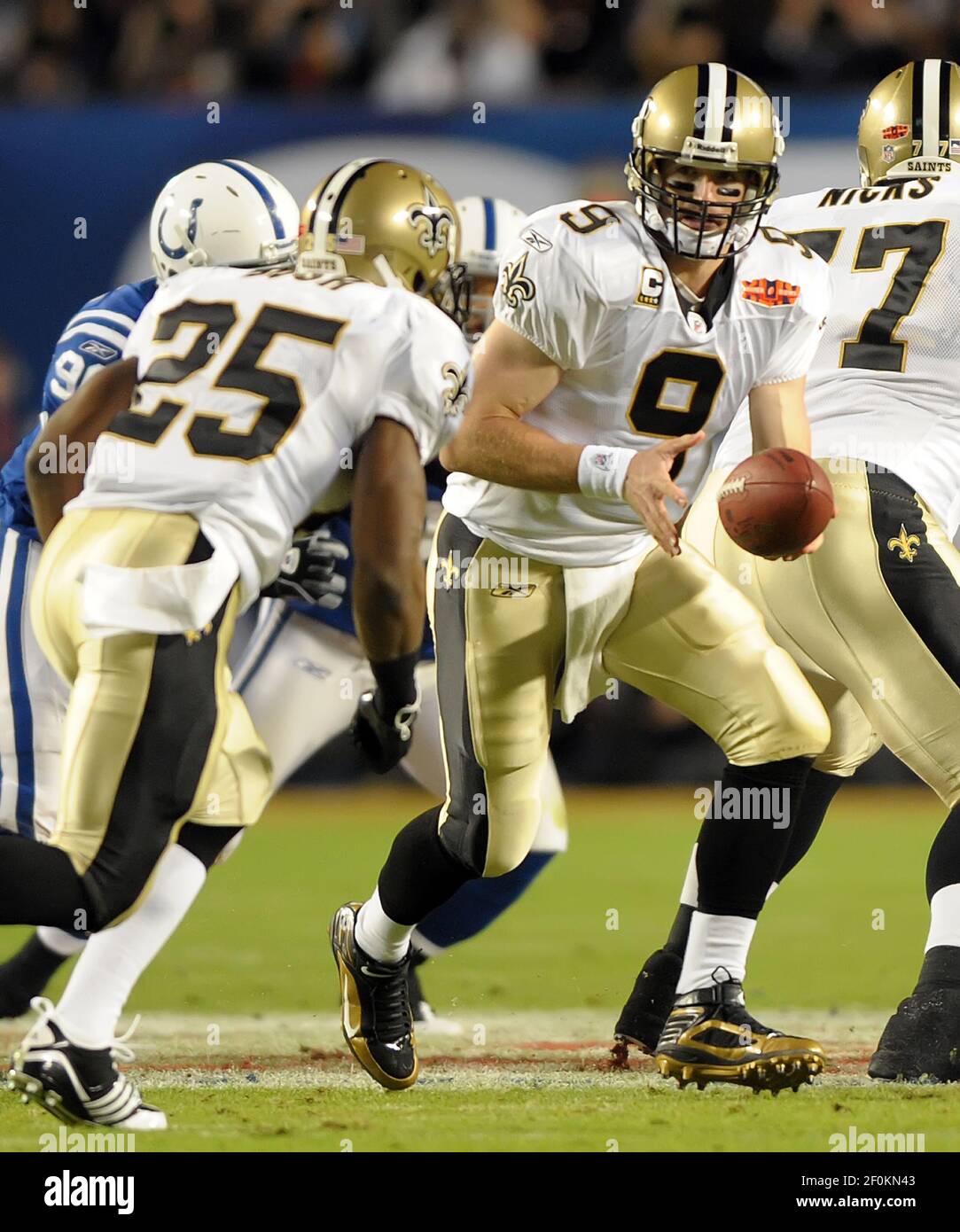 New Orleans Saints quarterback Drew Brees hands off the ball to running ...