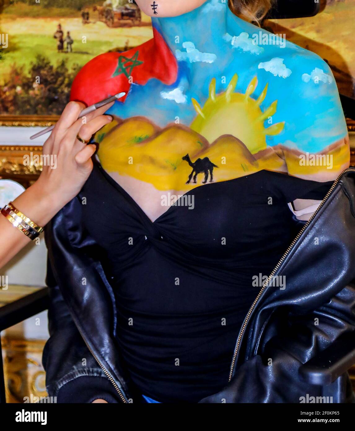 An artist draws the Moroccan flag on a woman's body. The concept of ...