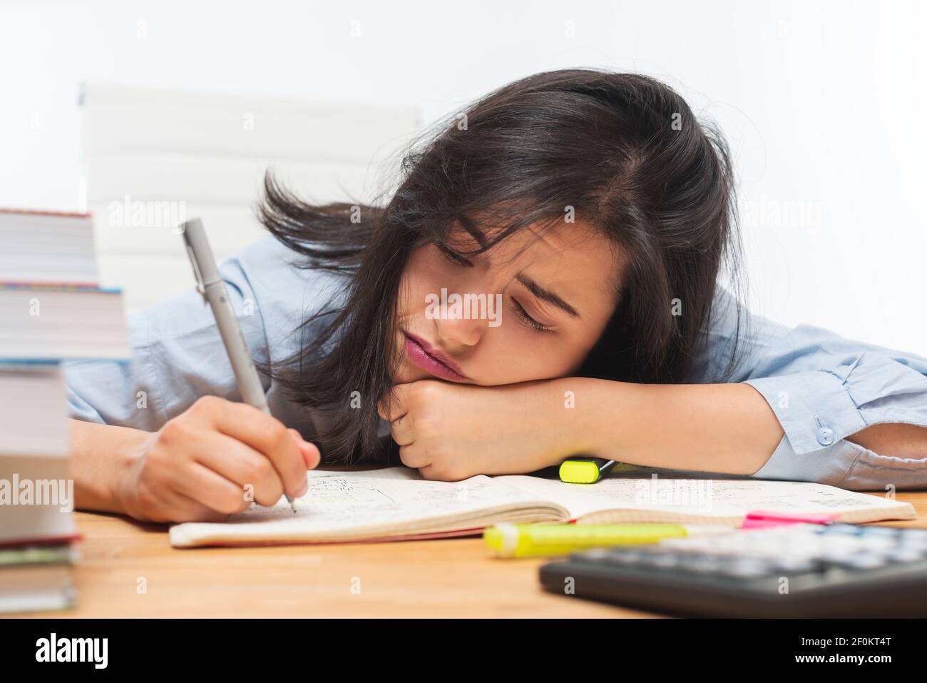 Portrait of a tired girl doing study Stock Photo - Alamy