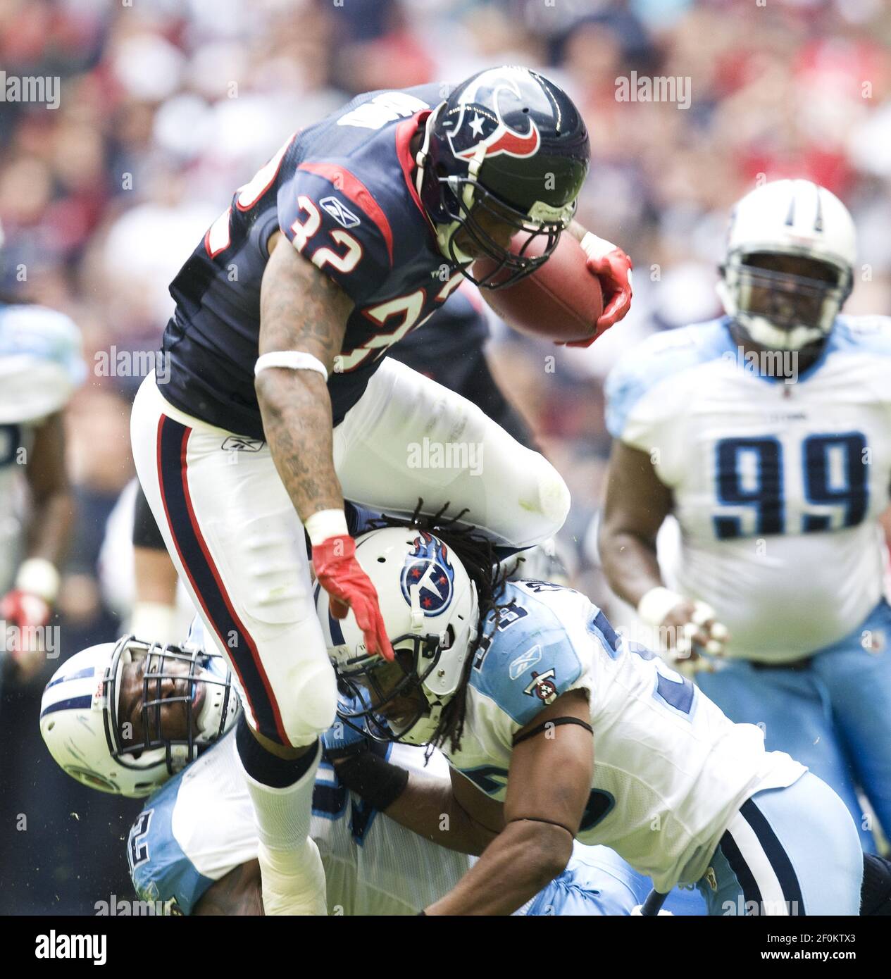 Derrick Ward (32) of the Houston Texans is hit by Will Witherspoon (92 ...