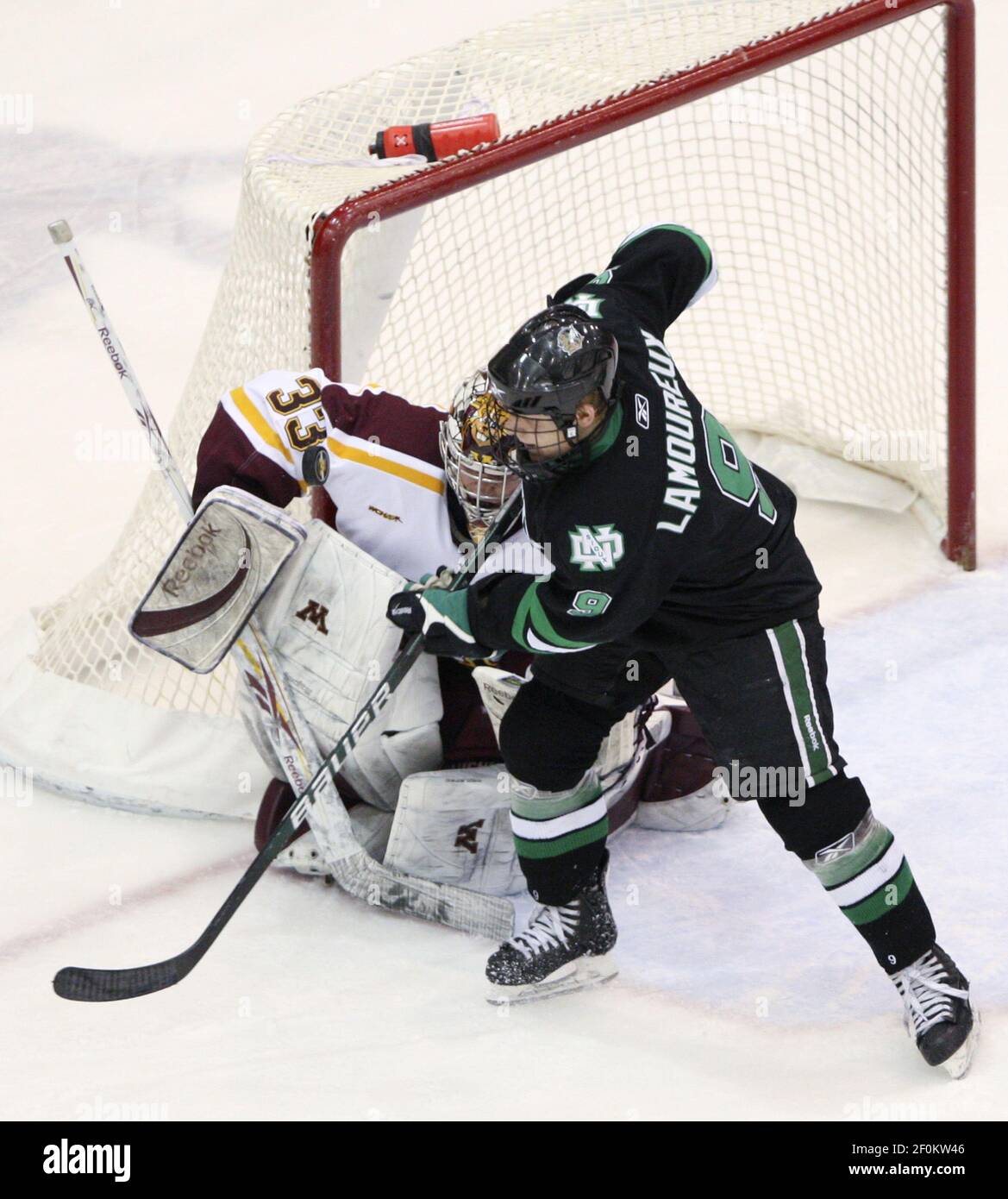 North Dakota's Mario Lamoureux tried to deflect a shot in front of ...