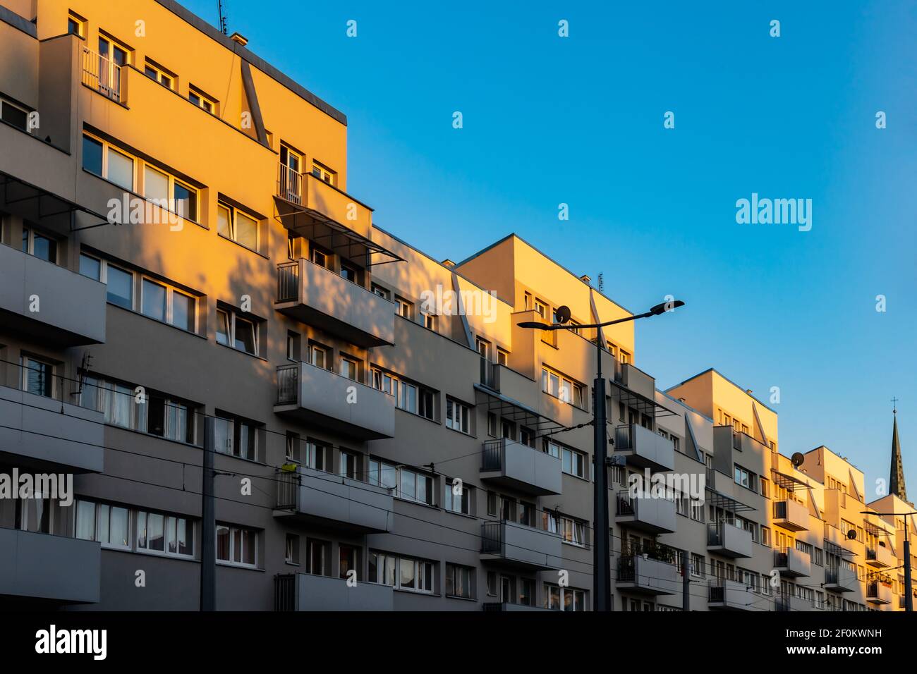 Long block of flats with balconies highlighted by sunset Stock Photo ...