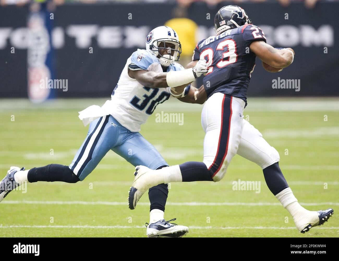 Jason McCourty (30) of the Tennessee Titans grabs Arian Foster (23) of ...