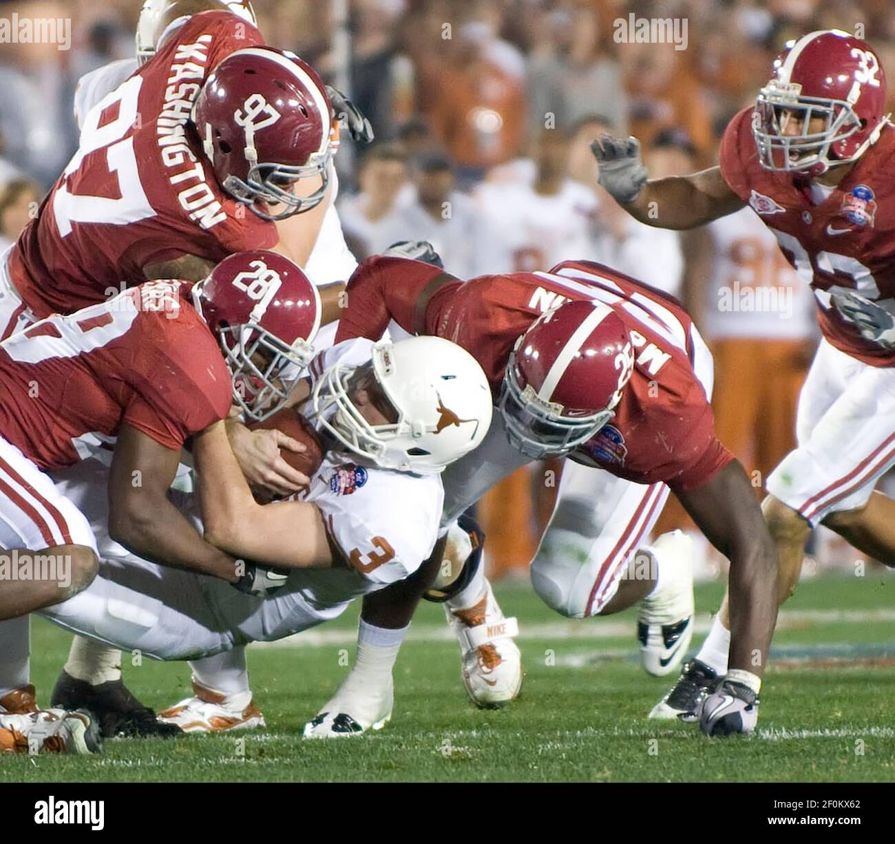 Texas quarterback Garrett Gilbert is brought down by the Alabama ...