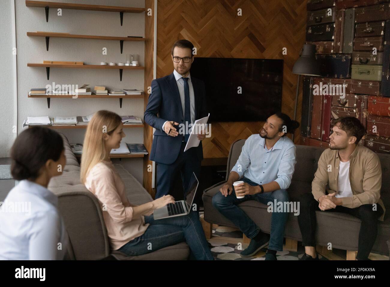 Confident businessman wearing suit leading corporate meeting with ...