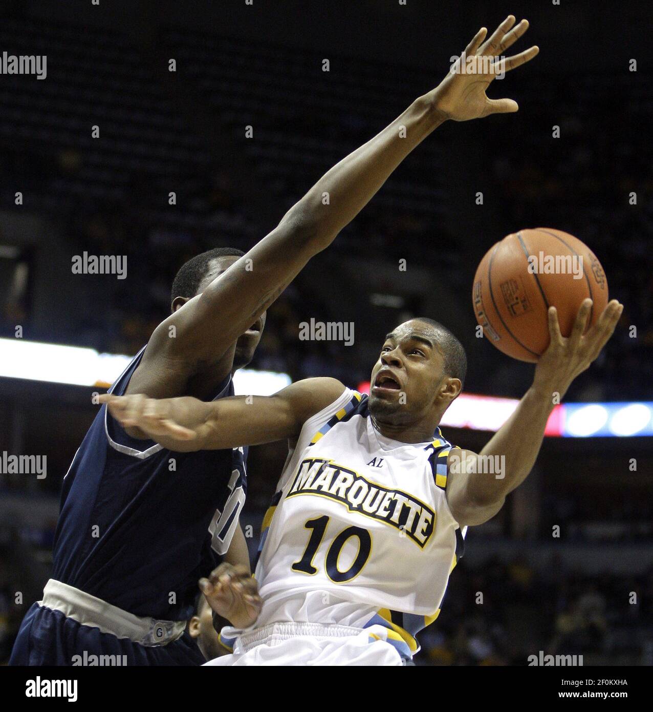 Marquette's David Cubillan drives on Georgetown's Henry Sims in a Big ...