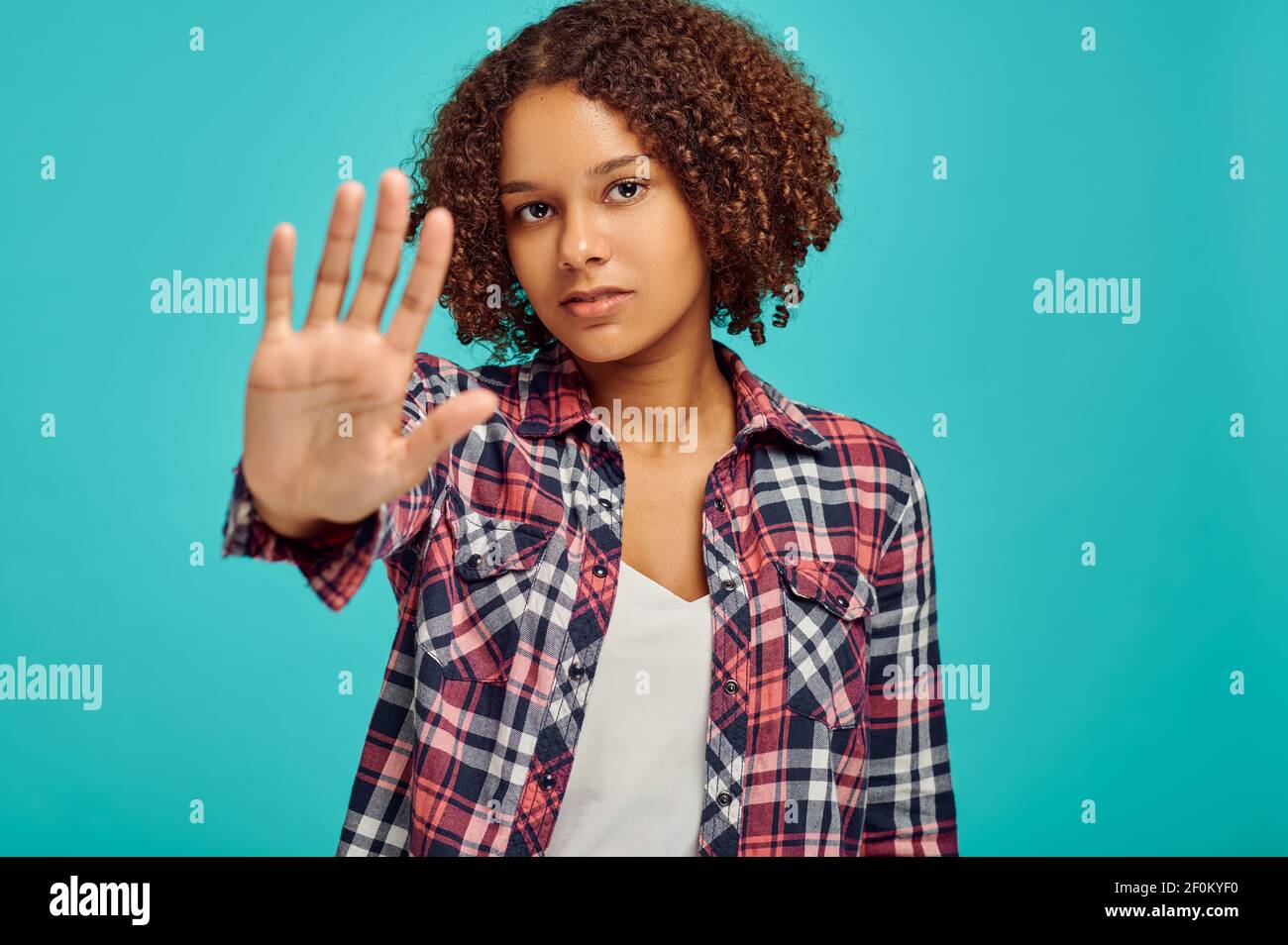 Woman shows stop sign, blue background, emotion Stock Photo - Alamy Woman shows stop sign, blue background, emotion Stock Photo - Alamy