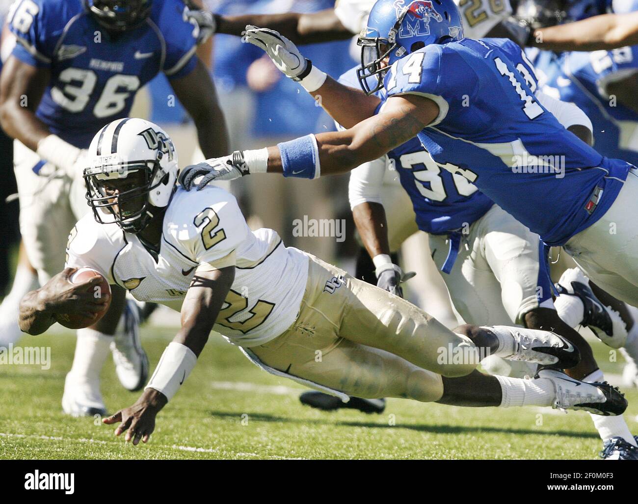 Central Florida quarterback Jeff Godfrey leaps for yardage against the ...