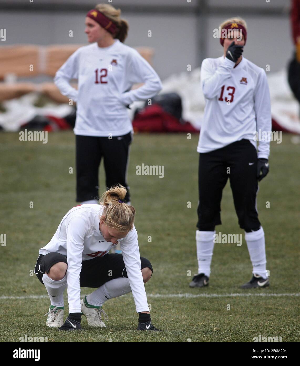 Minnesota's Jennie Clark kneels near mid-field to collect her thoughts ...