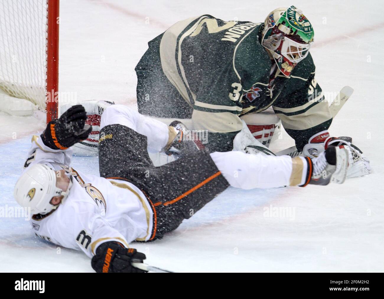 Minnesota Wild goalie Niklas Backstrom, right, holds onto the puck as ...