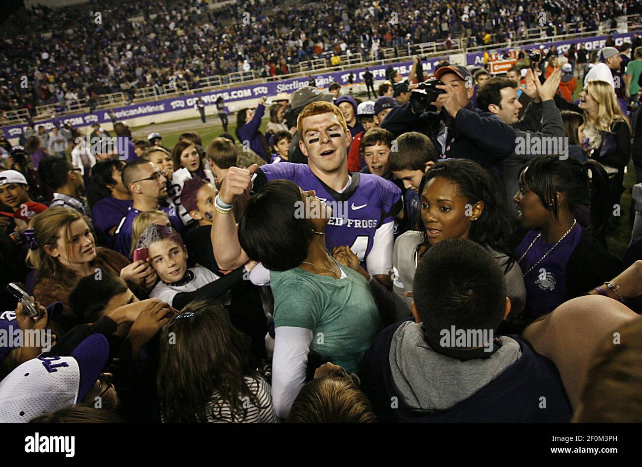 Texas Christian quarterback Andy Dalton is swarmed by fans after the ...
