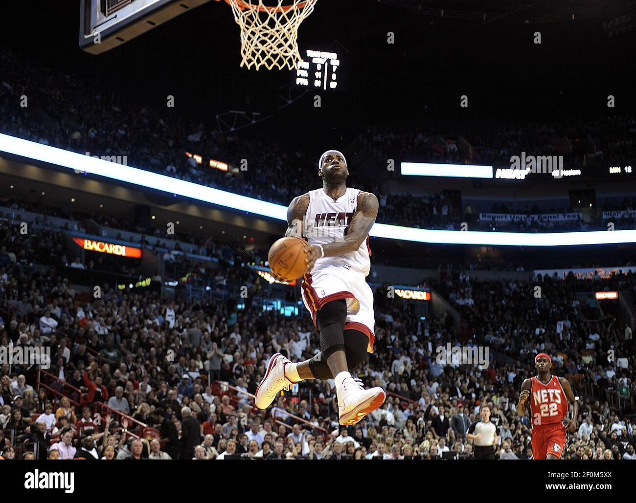 Miami Heat forward LeBron James sails through the air before dunking ...