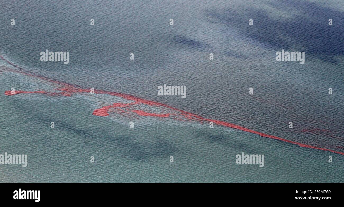 A long ribbon of rust colored oil stretches off into the distance near ...