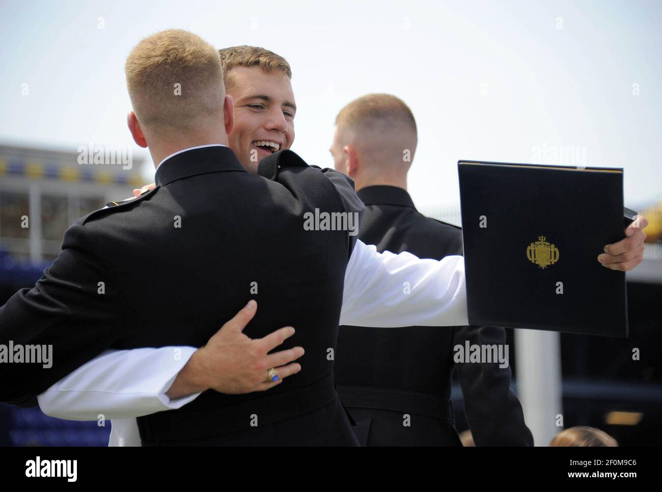 Sean Kitchen, facing camera, of the Naval Academy embraces best friend ...