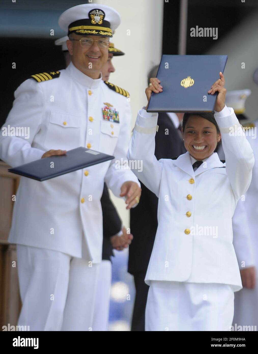 Kristina R. Fontenot, right, of Suffolk, Virginia, holds up her diploma ...