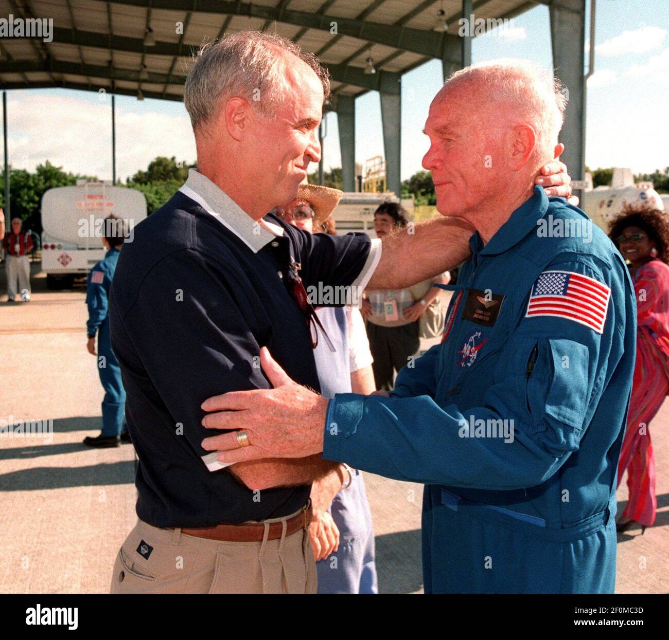 STS-95 Payload Specialist John H. Glenn Jr. (right), senator from Ohio, embraces his son, David ...